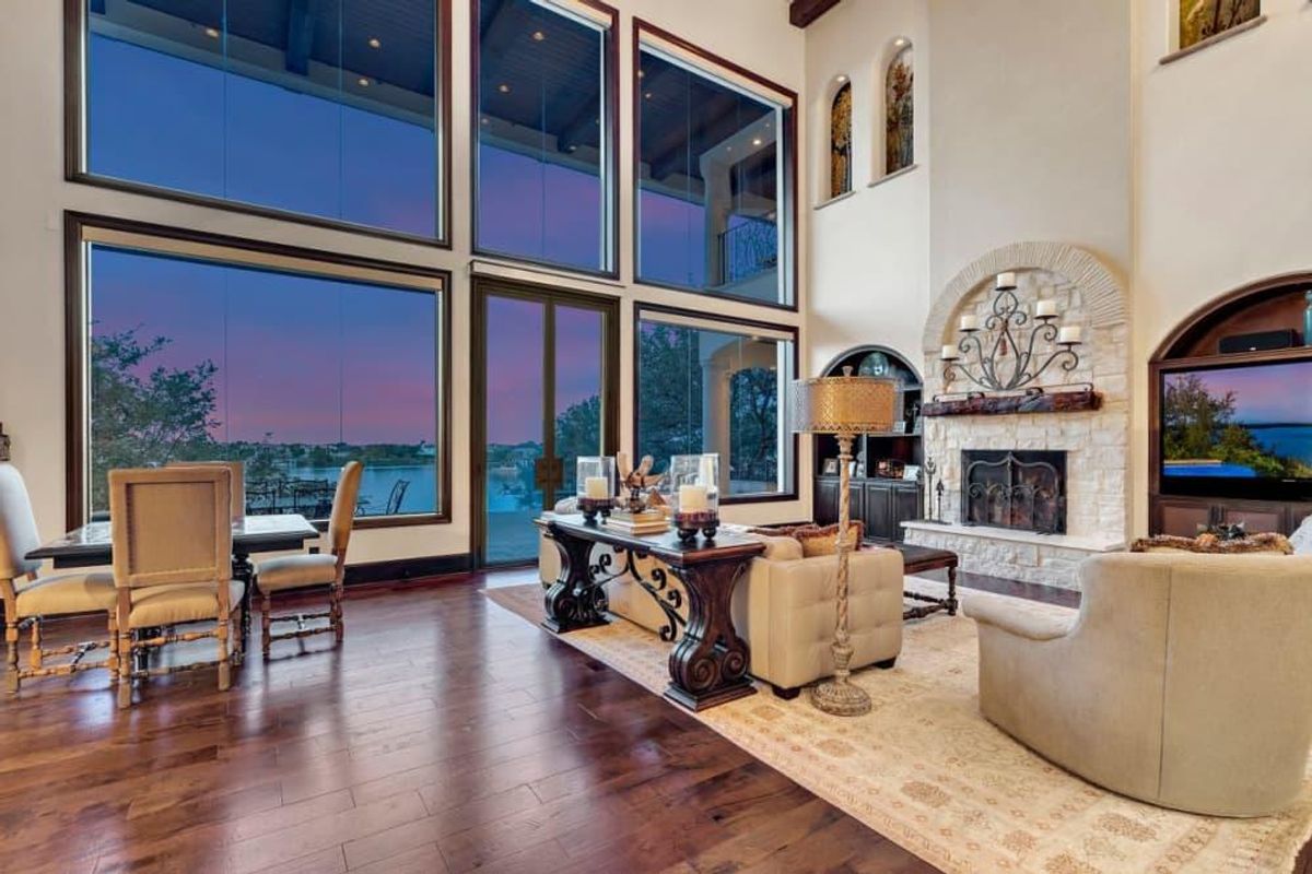 Enjoy the lake views through the 24-foot, floor-to-ceiling butted glass ...