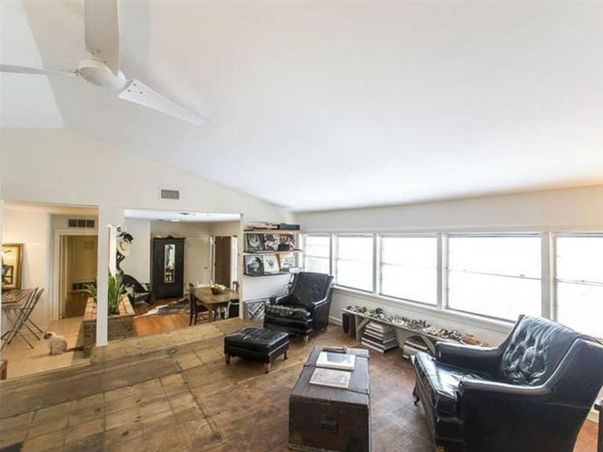 An open floor plan seamlessly blends the dining, living, and kitchen ...