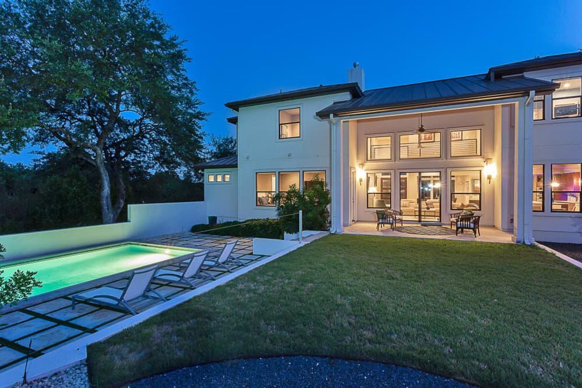 A grassy green space gives kids and dogs somewhere to play ...