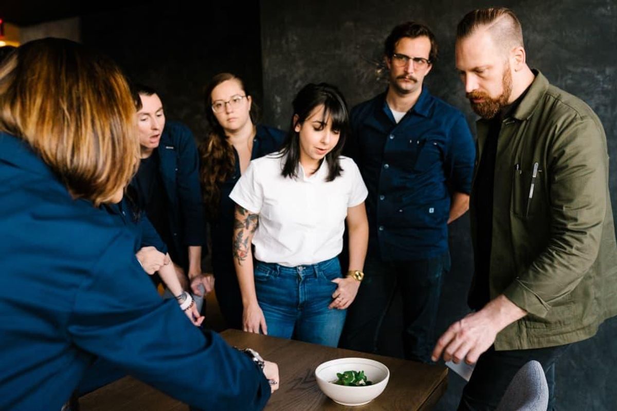 Chef Kevin Fink meets with his staff before service to discuss the ...