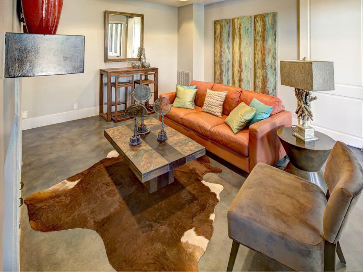 The cozy, rustic living room in this Austin home features wooden ...